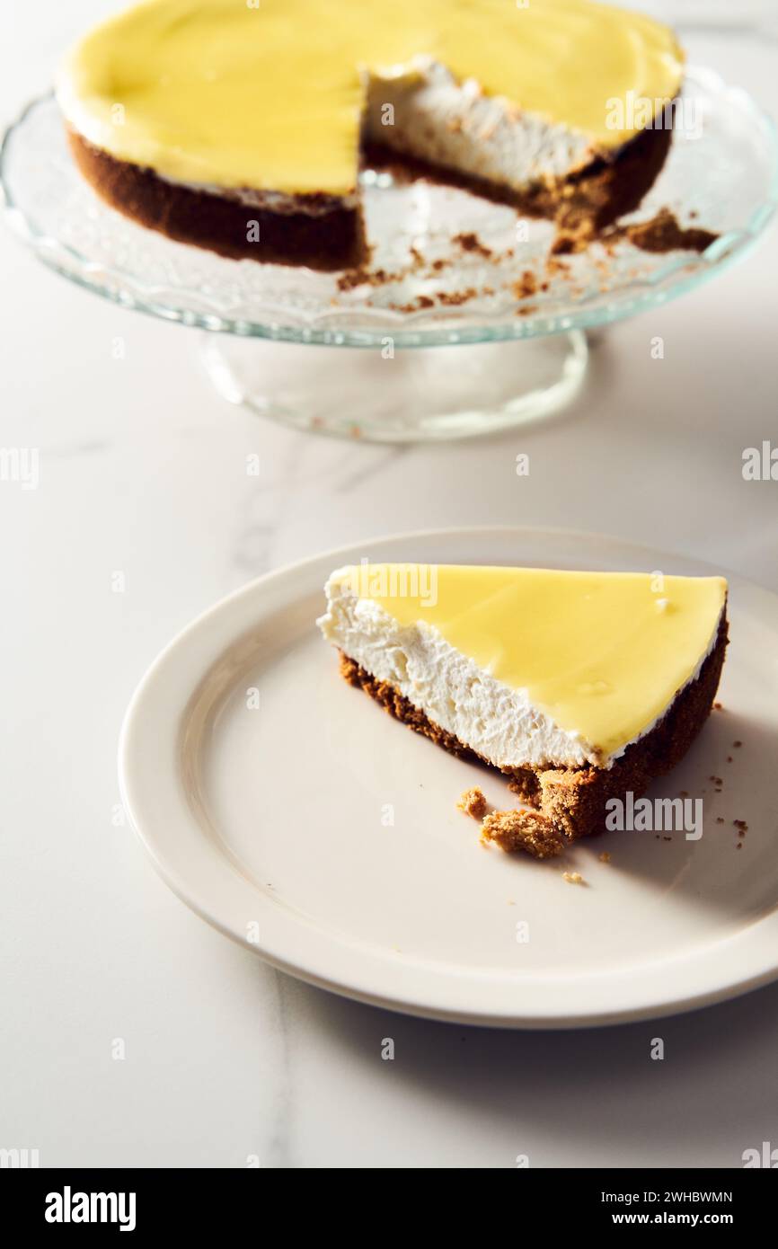 Mascarpone cheesecake with lemon curd and shortbread base. White marble ...