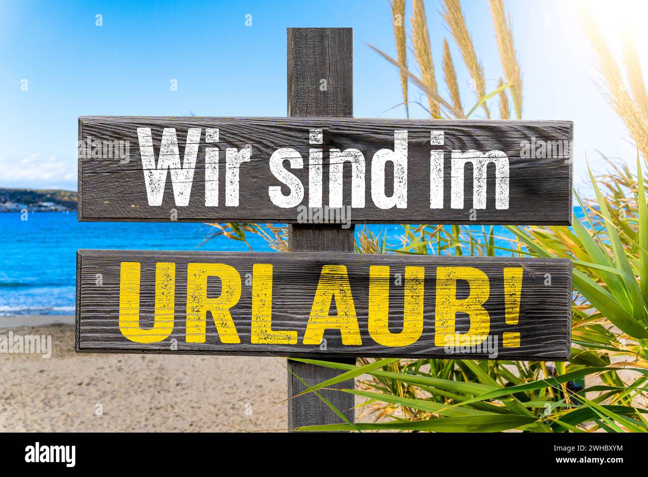 9 February 2024: We are on vacation Wooden sign on the beach and sea in the sunshine ...
