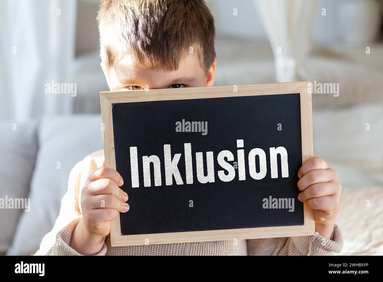 February 9, 2024: A little boy holds a plaque with the inscription ...
