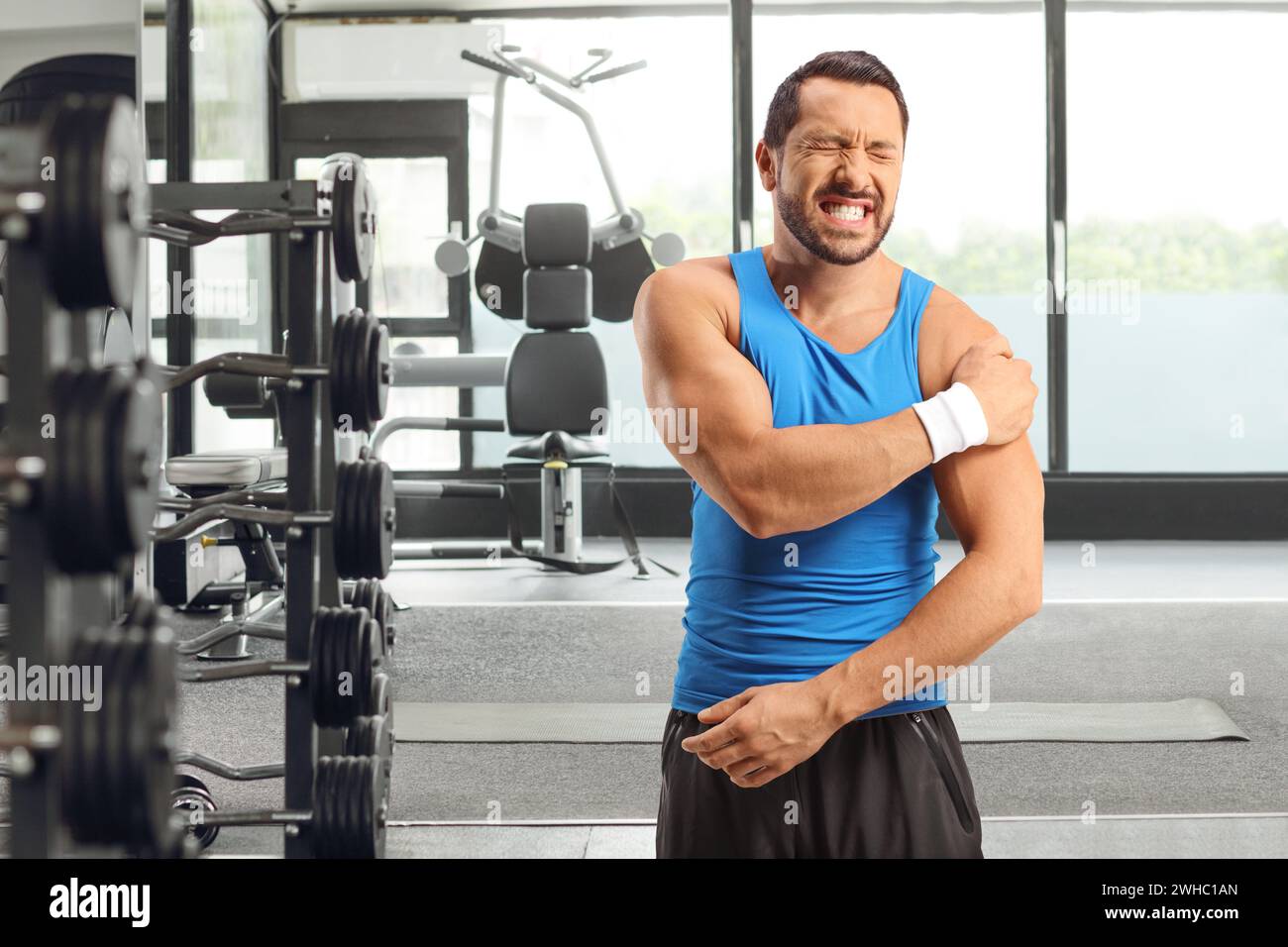 Man at the gym with sports injury on his shoulder Stock Photo - Alamy
