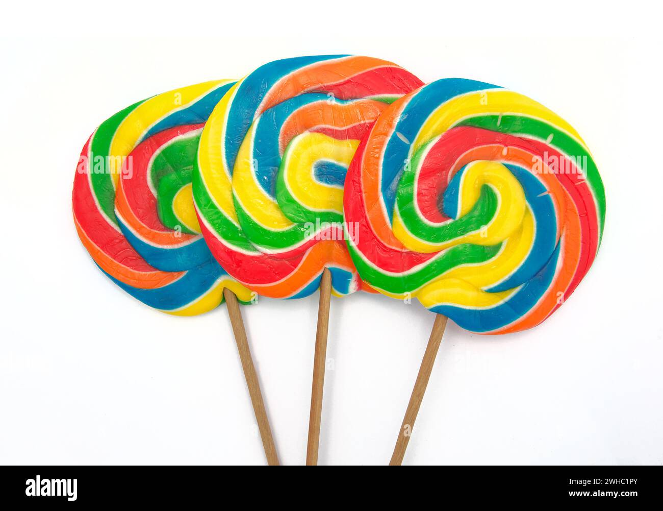 Three lollipops on white background Stock Photo - Alamy