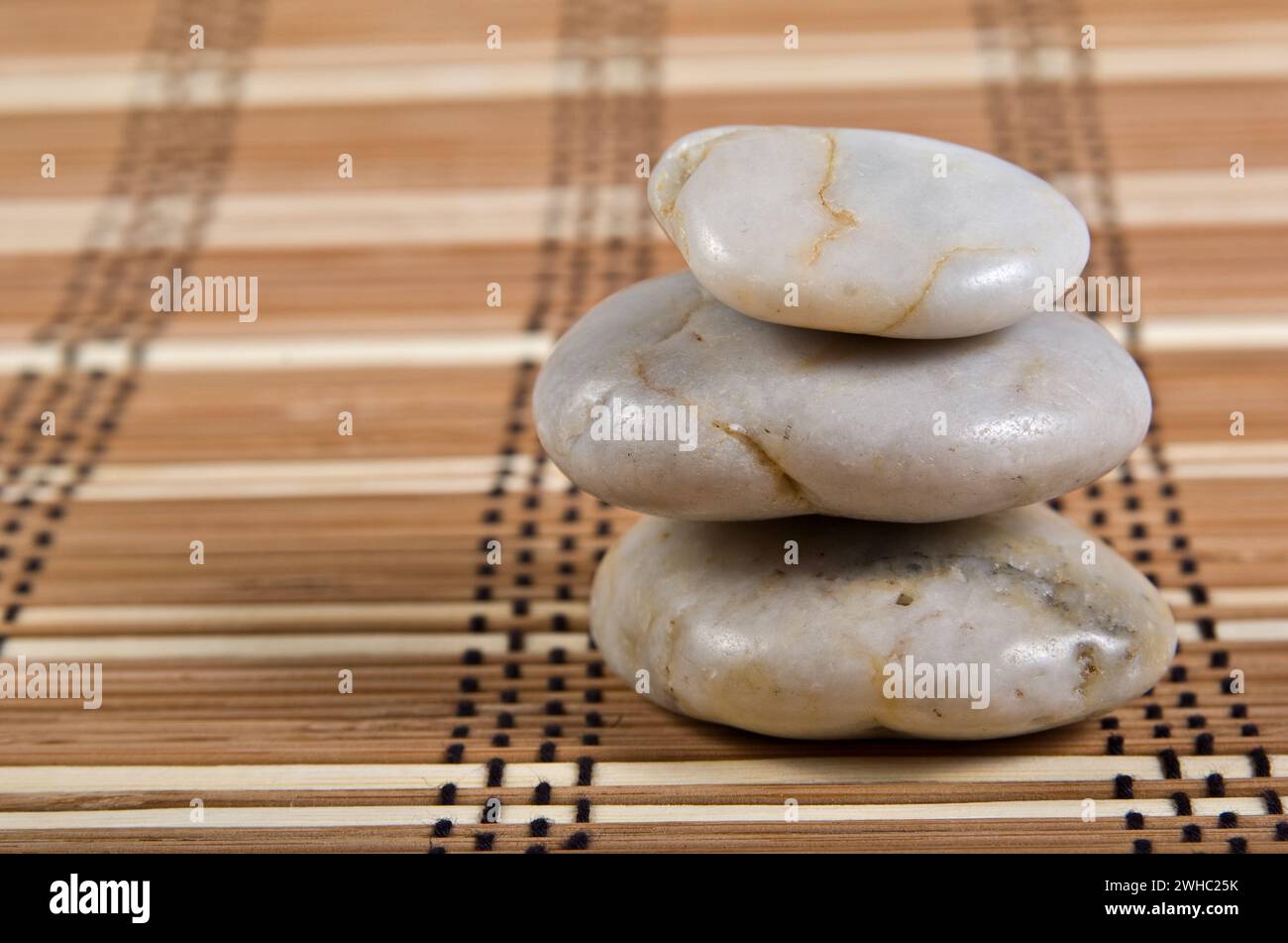 Stones on wood mat Stock Photo - Alamy
