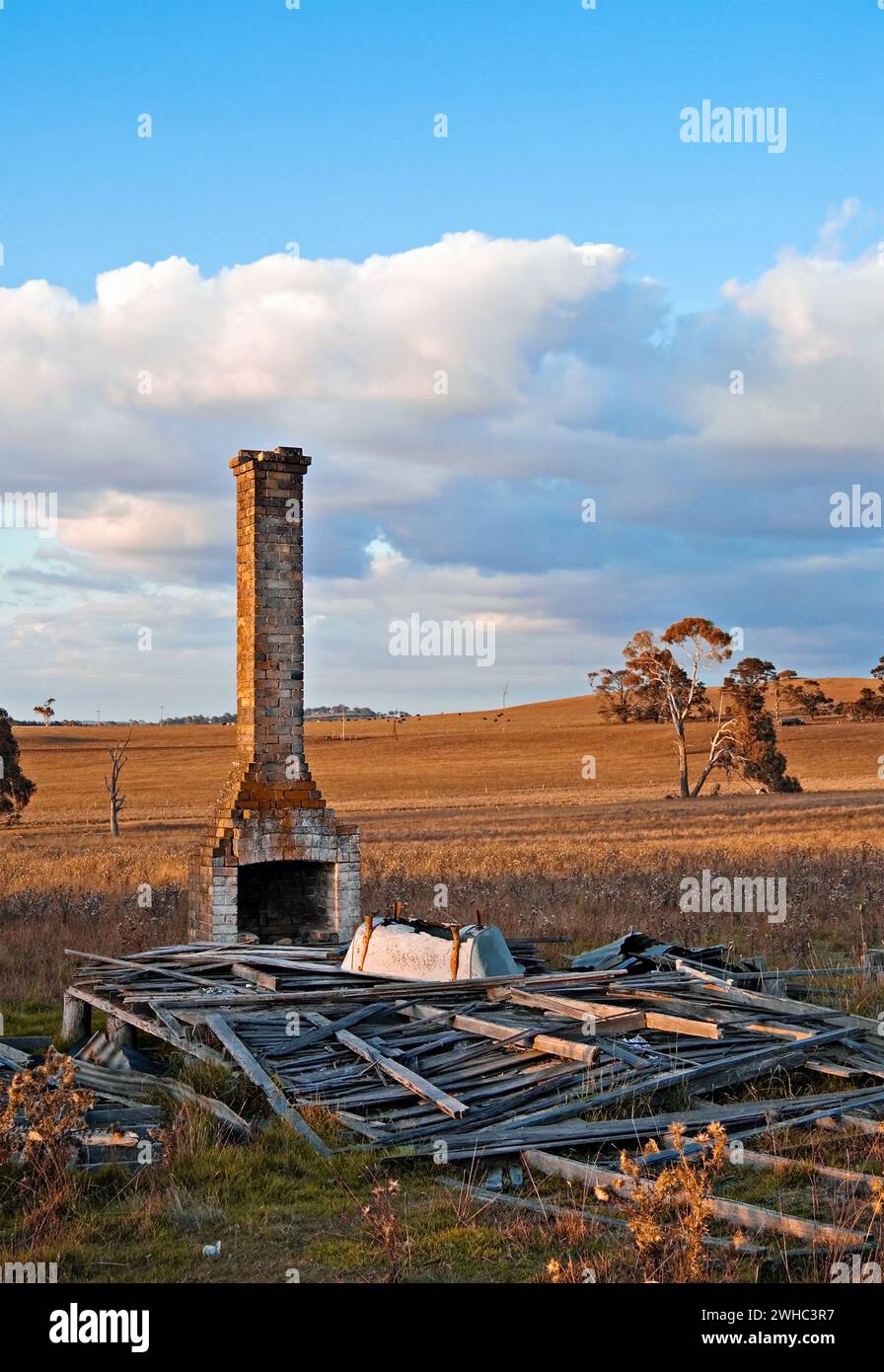 all that is left of this old farmhouse is a chimney, a pile of wood and ...