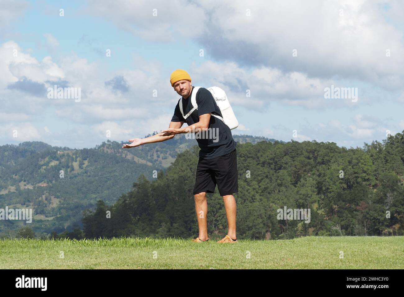 Welcome to nature, man having fun on top of mountain Stock Photo - Alamy