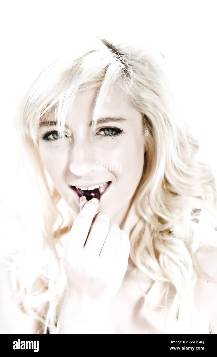 High key woman eating cherry Stock Photo - Alamy