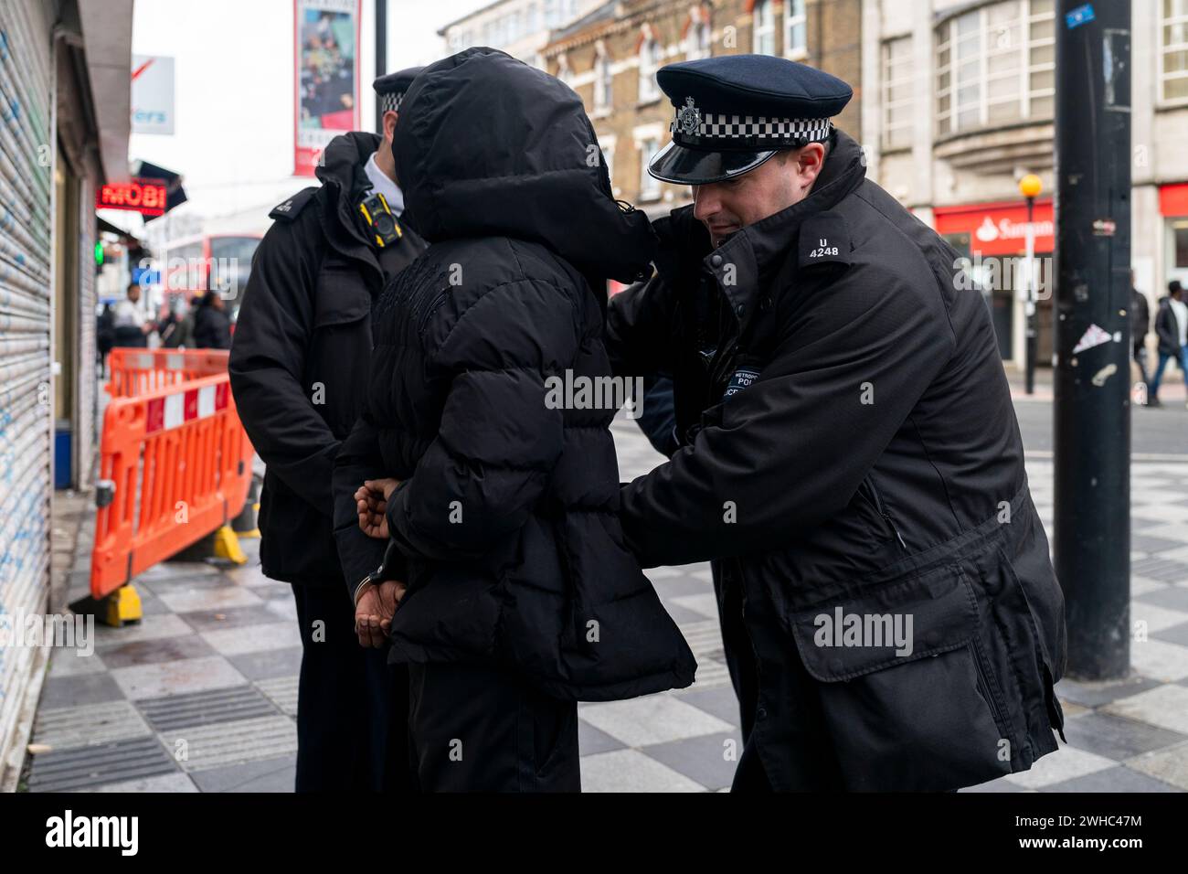 A person is detained by Metropolitan Police officers in Croydon, south ...