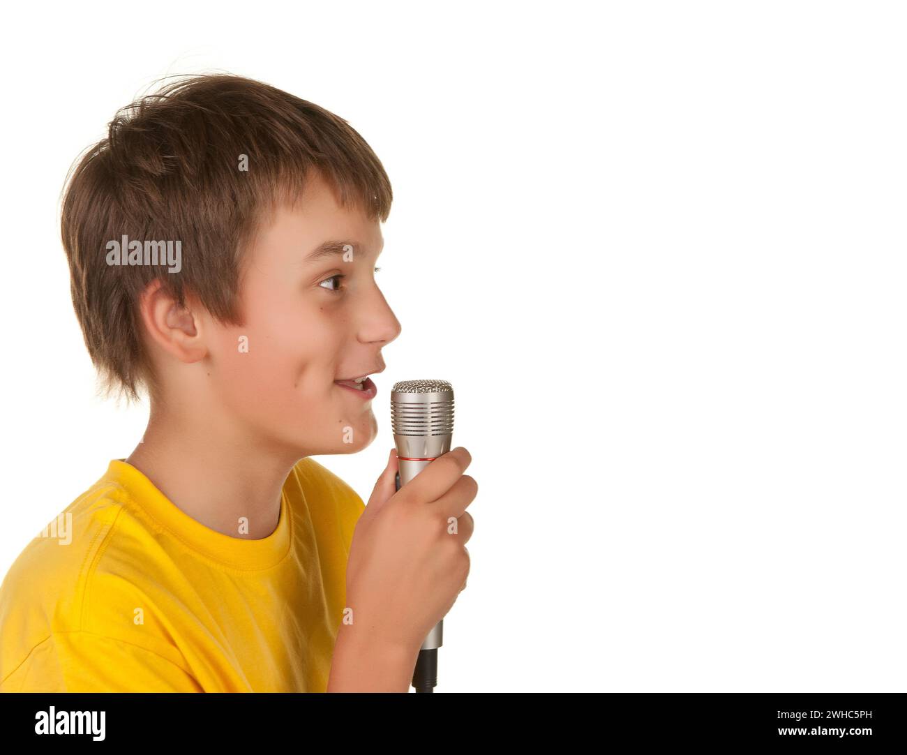 Boy speking with microphone Stock Photo - Alamy