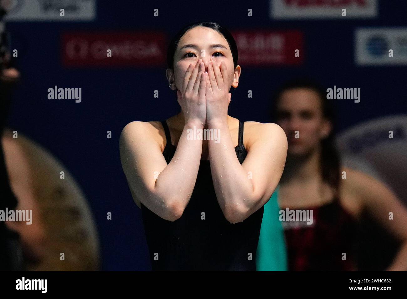 Kim Suji of South Korea reacts as she sees the scoreboard during the ...