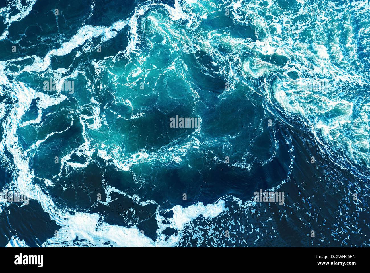 Aerial top view of dynamic movement of ocean water, swirling patterns ...