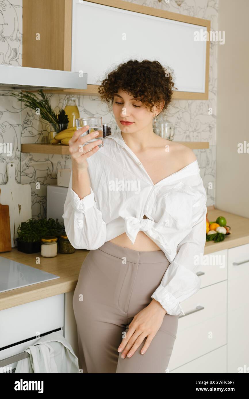 A young woman takes care of her health and proper digestion. She starts ...