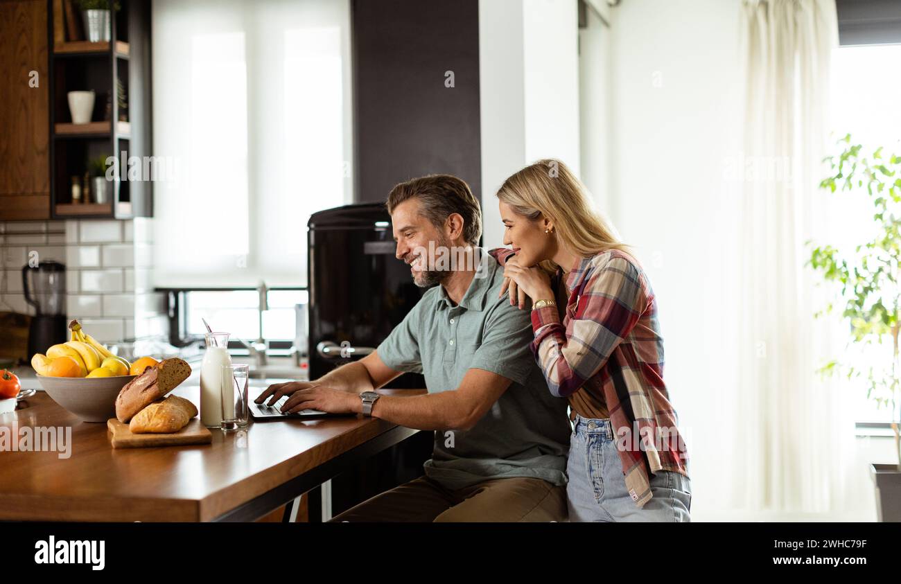 Smiling couple shares a moment of togetherness as they sit by the ...