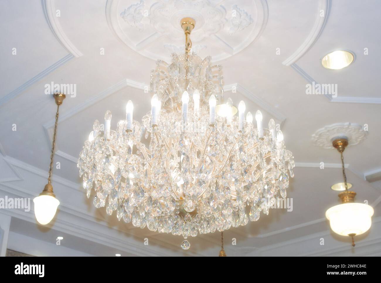 Chandelier hanging from ceiling Stock Photo - Alamy