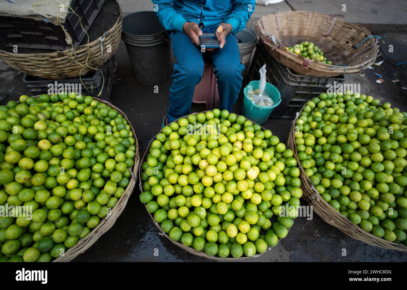 Vendor selling lemons at a market, ahead of the presentation of the ...