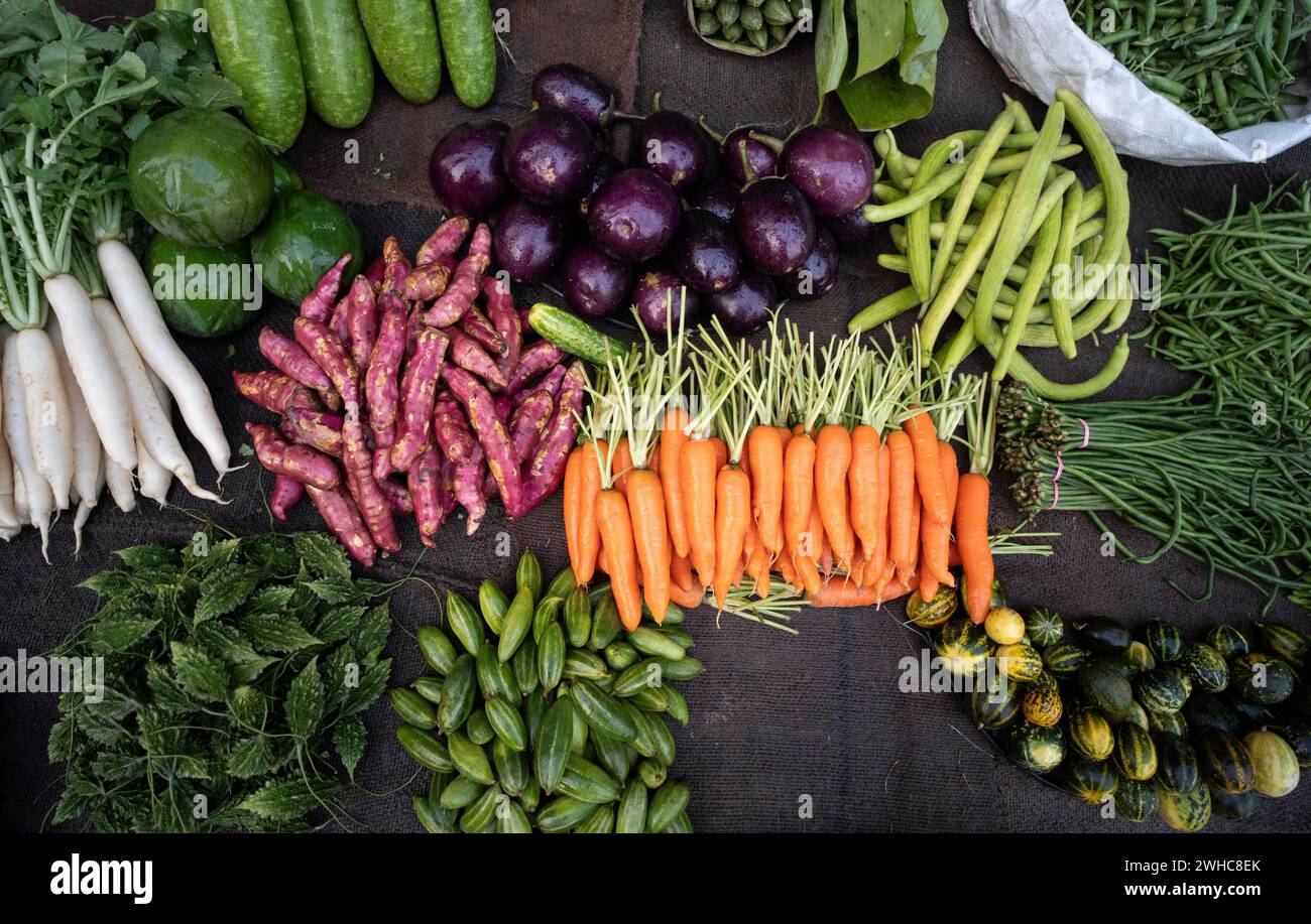Vendor selling vegetables at a market, ahead of the presentation of the ...