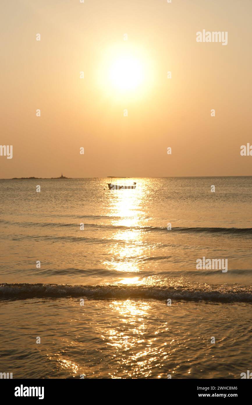 Tropical island sunset boat Stock Photo - Alamy