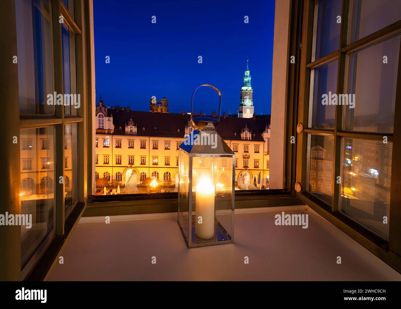 Lamp with a candle in the window, view to the market square of Wroclaw ...