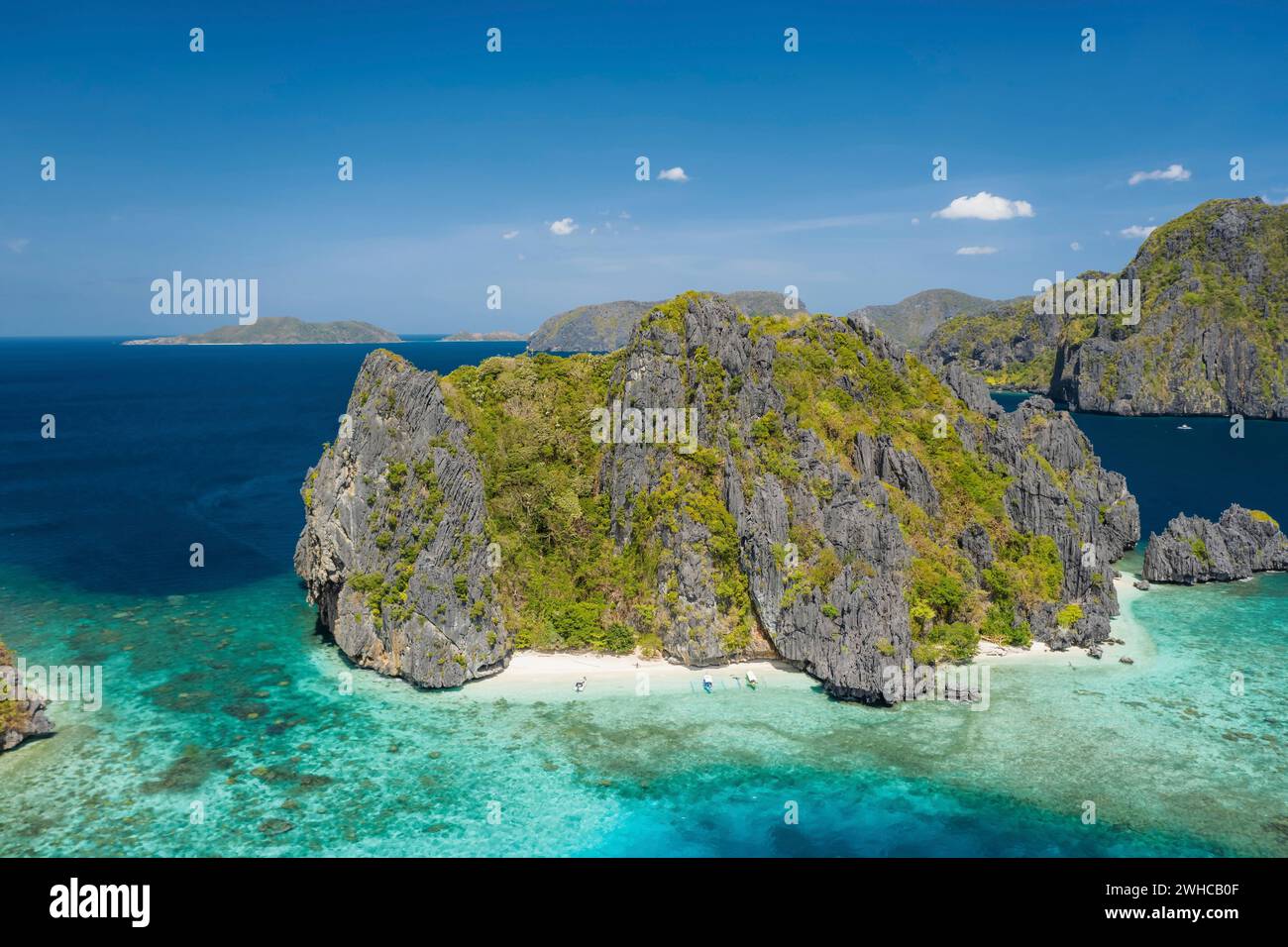 Aerial panoramic view of a tiny tropical island with beach, coral reef ...