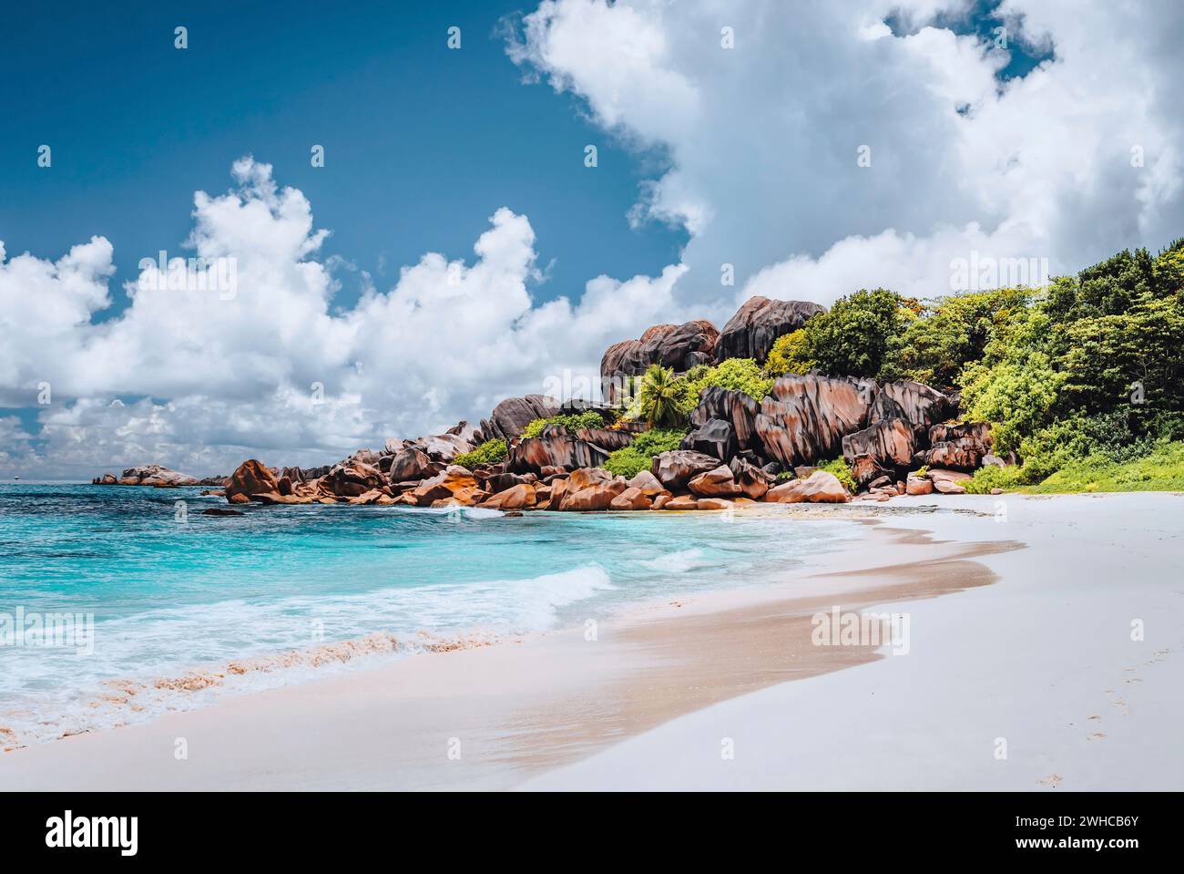 Grand Anse tropical beach in La Digue, Seychelles. Famous granite rock ...