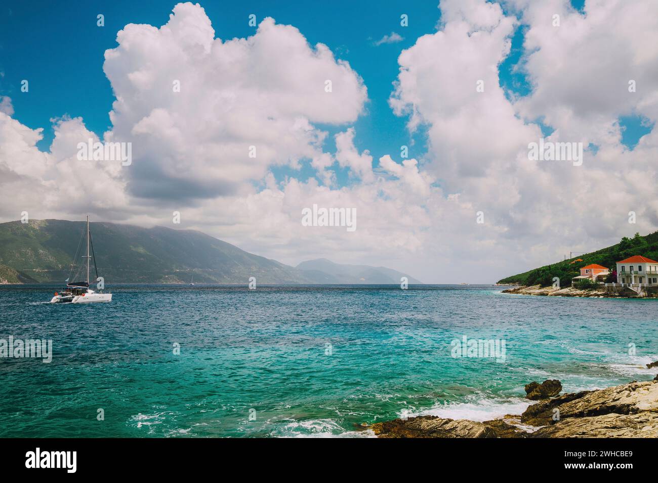 White yacht going to open sea under amazing white endless cloudscape ...