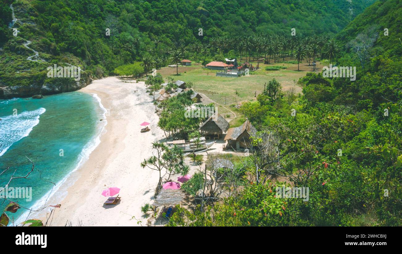 Lila Sunbed on beautiful idyllic white sand Atuh beach. Clear blue ...