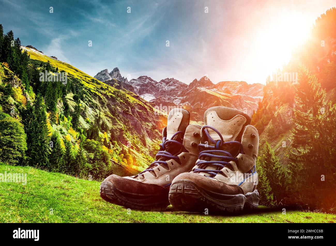 Mountain boots in front of mountain landscapes in the European Alps ...