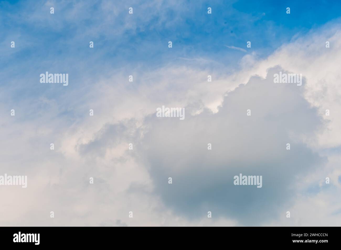 Layers of cirrocumulus and cirrus clouds in upper atmosphere in blue ...