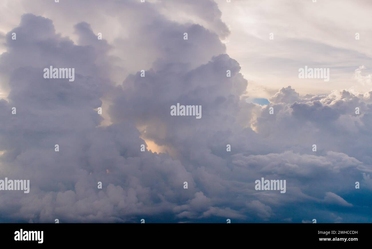 Layers of beautiful cumulonimbus cloud formations under higher layer of ...