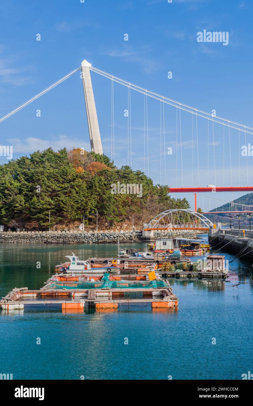Seascape of seaport with storage barges moored to pier and bridge in ...