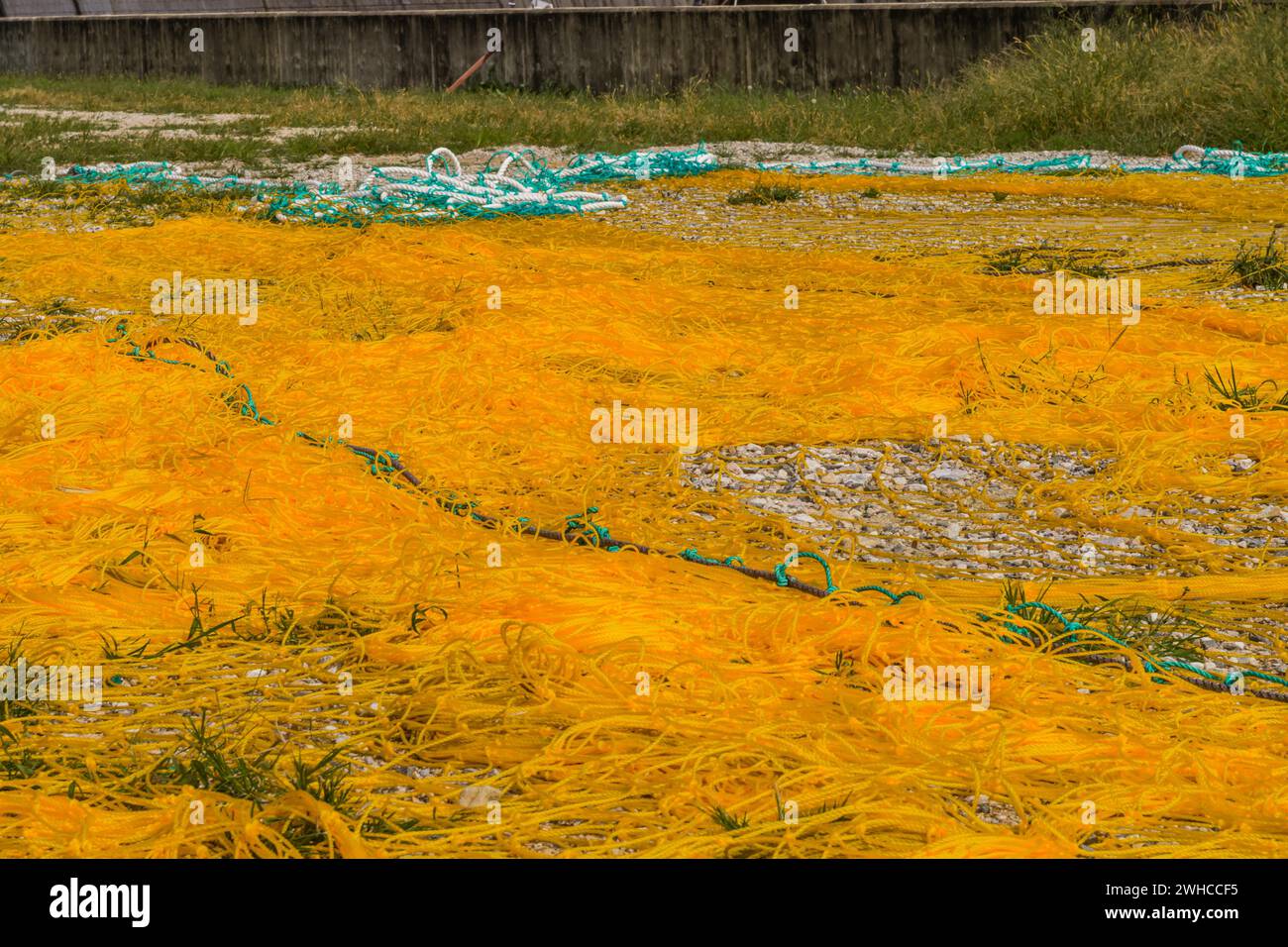 Closeup of large yellow fishing nets with yellow floats laid out on ...