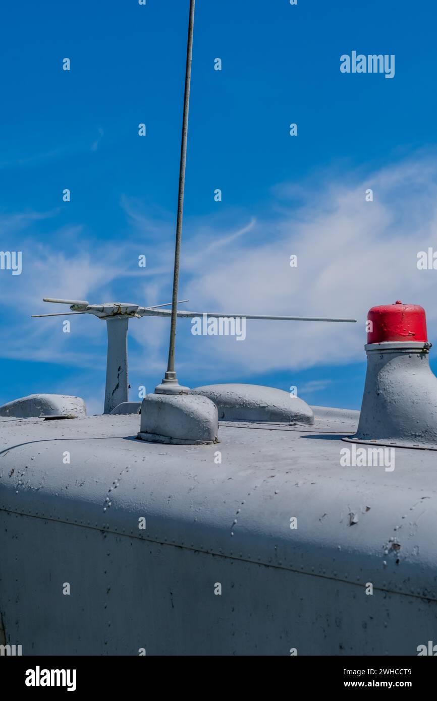 Radio antennas and red beacon light on top of antique airplane on ...