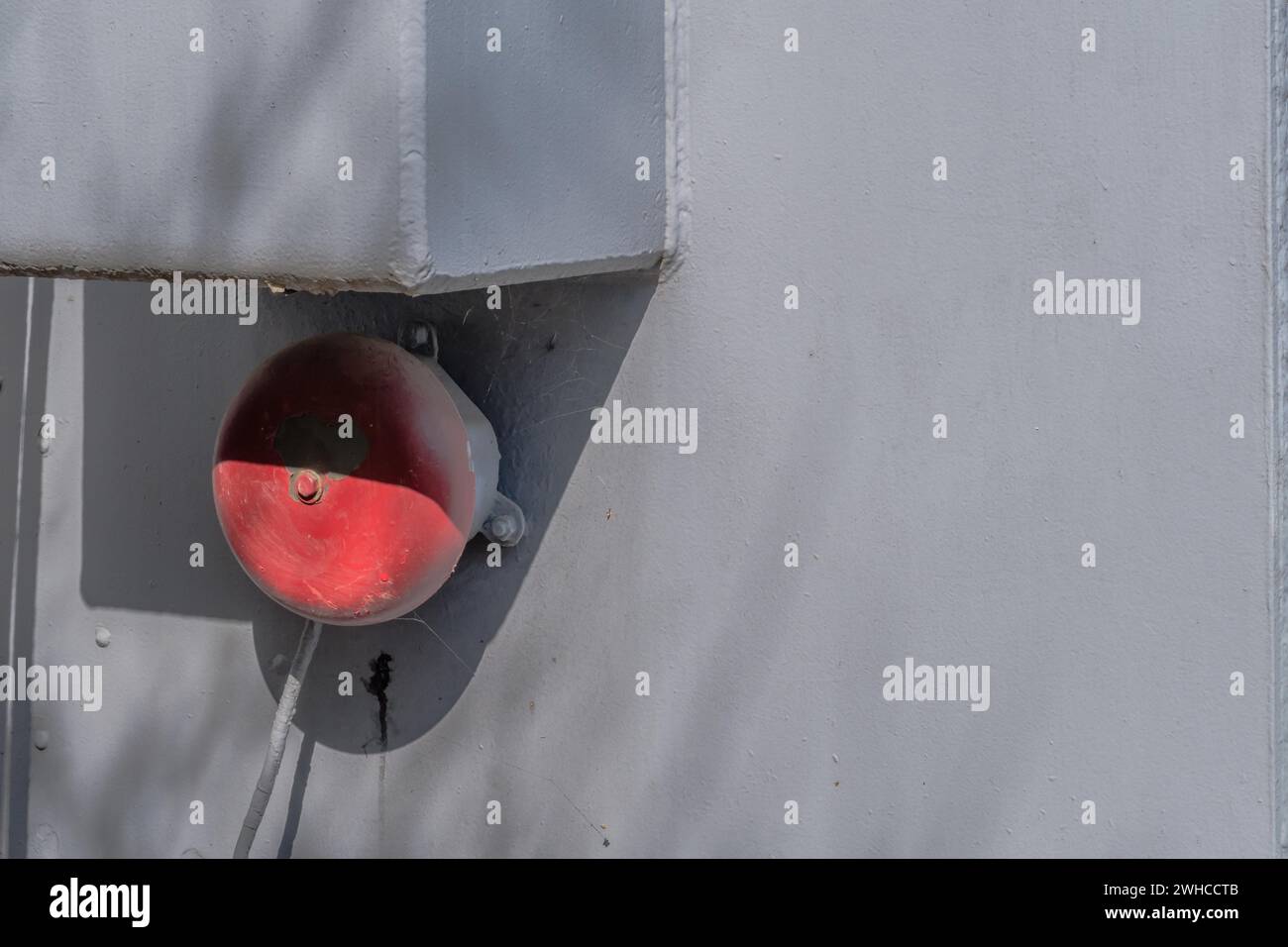 Red alarm bell on rear of military gun firing control system on display ...