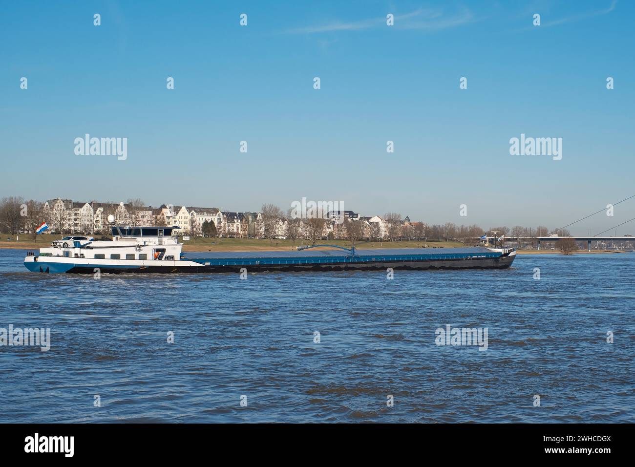 View over the Rhine with cargo ship, behind Oberkassel, Duesseldorf ...
