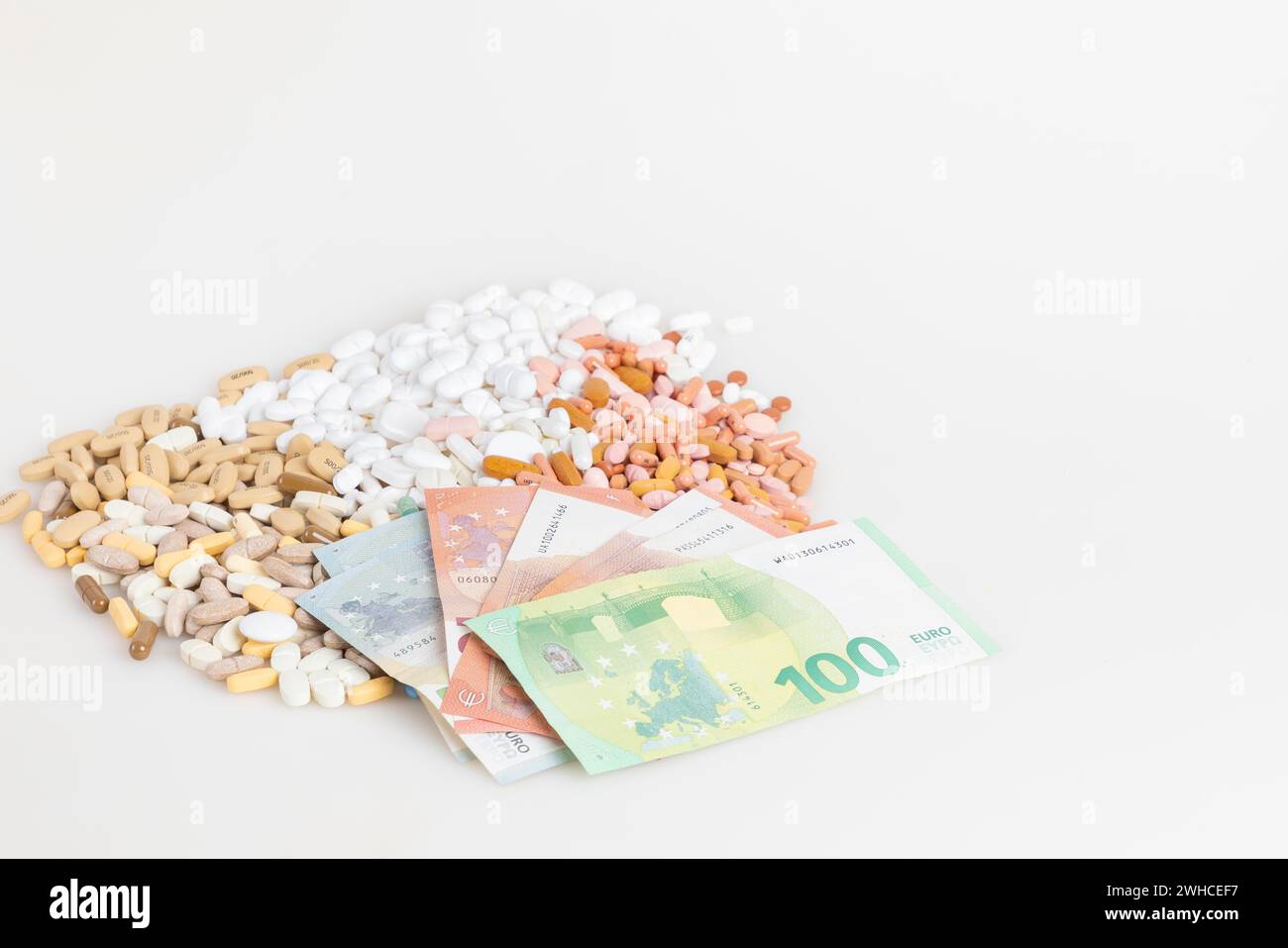 Various tablets and euro banknotes on top of each other, white ...