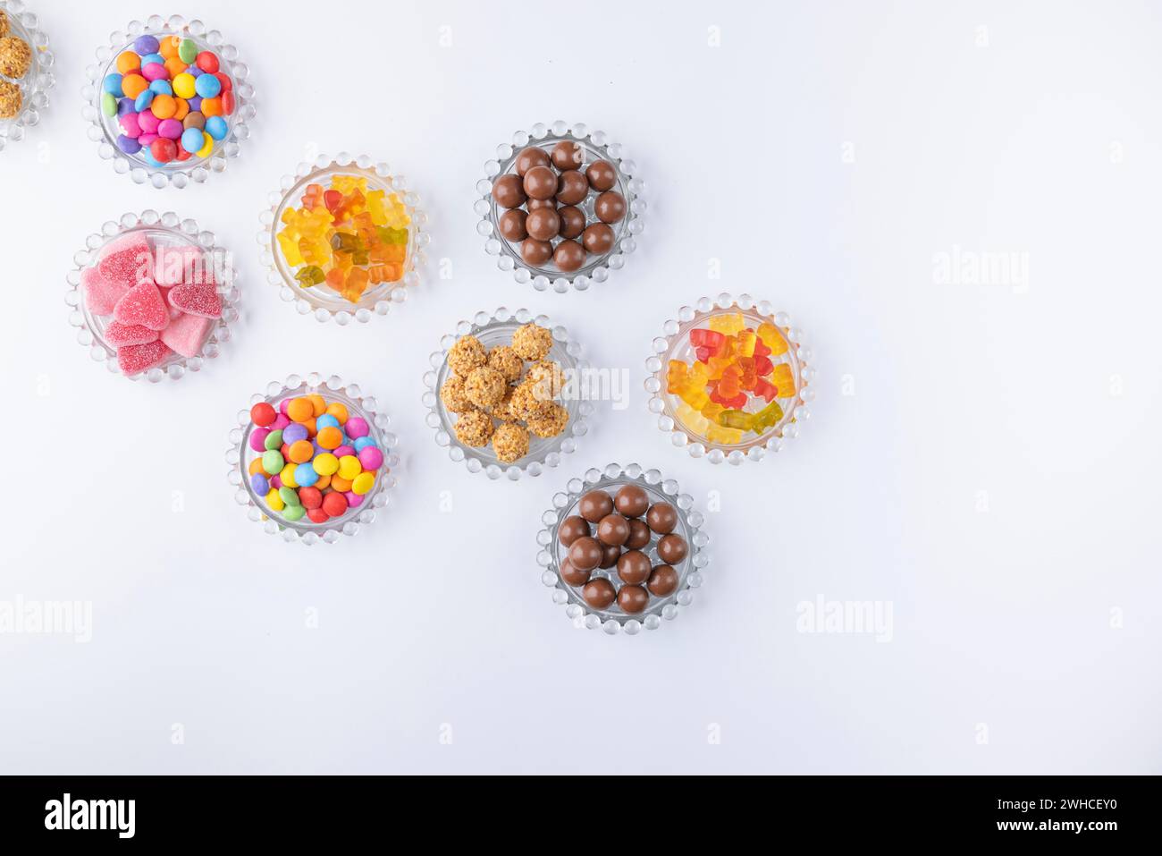 Sweets on small glass plates on a white background photographed from ...