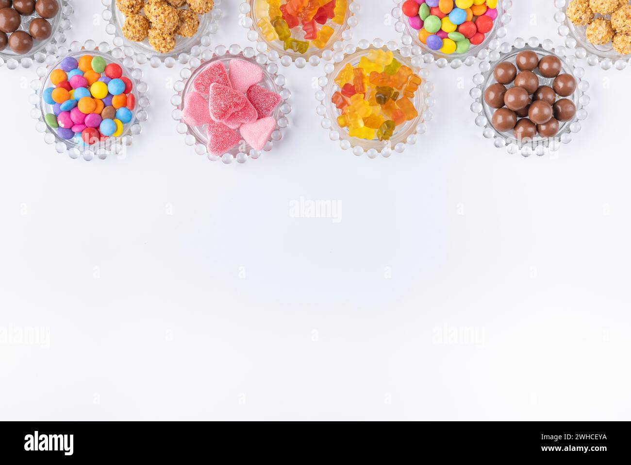 Sweets on small glass plates on a white background, copy room Stock ...