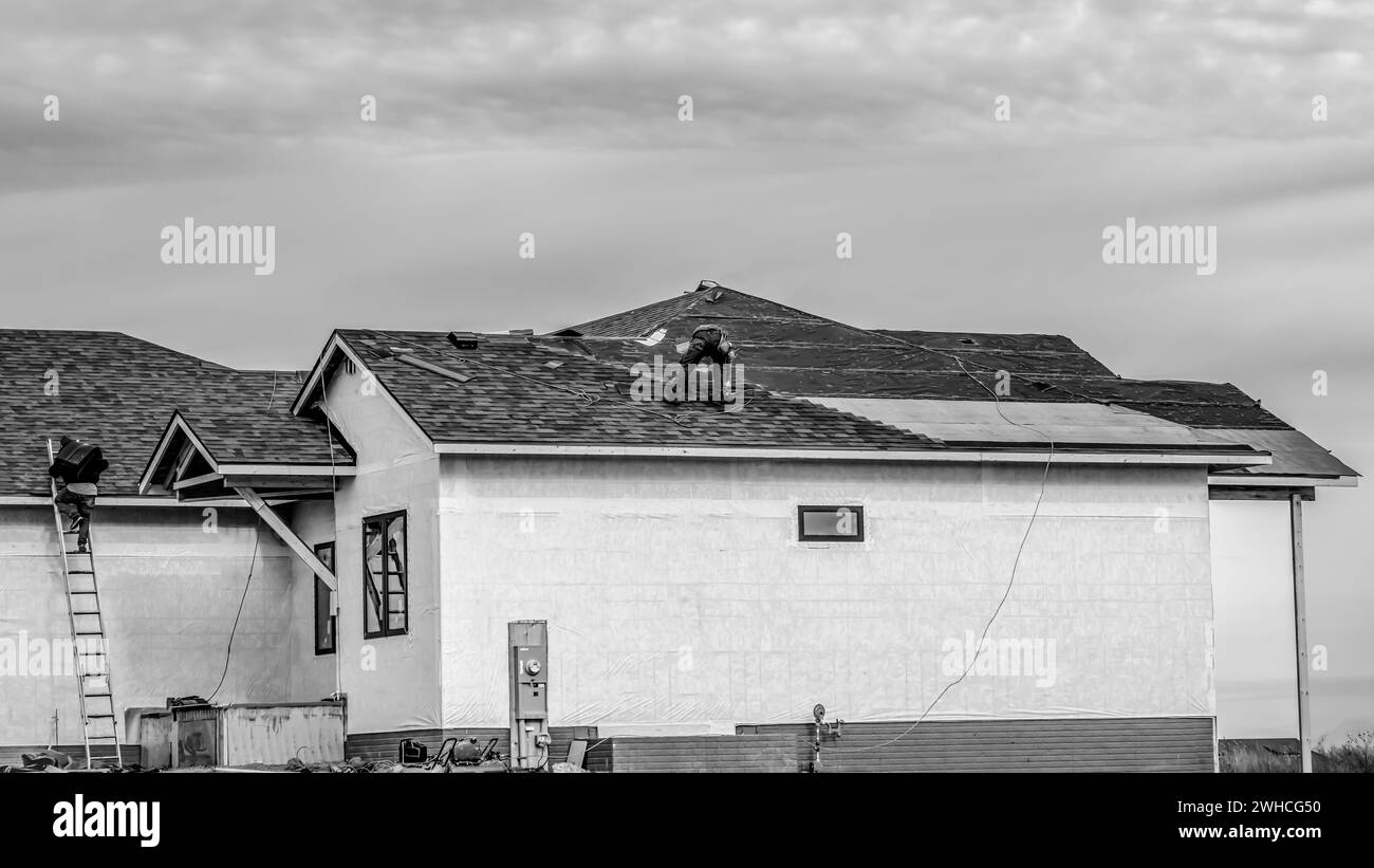 Shingle roof being installed on a two-story walkout new build ...