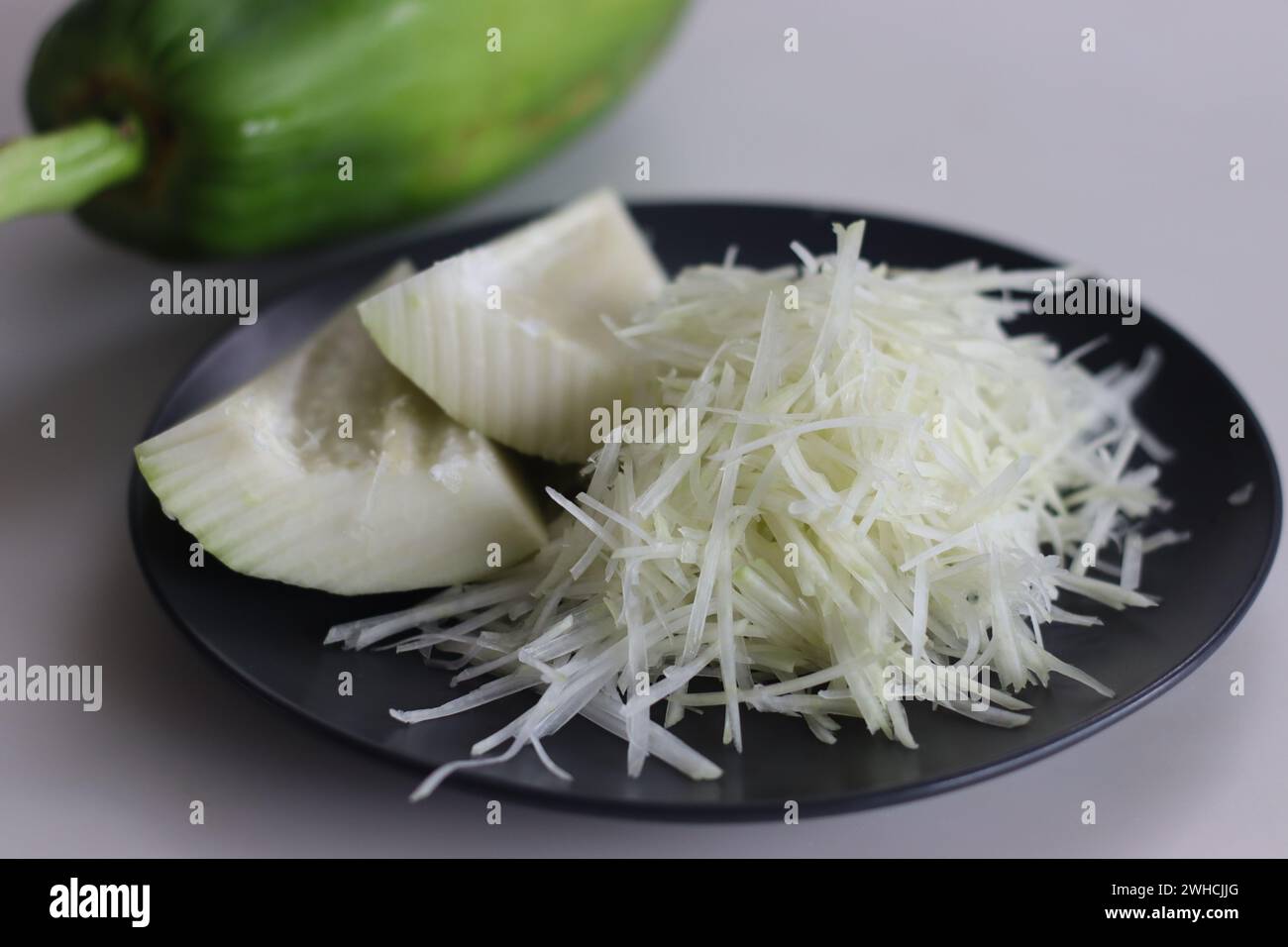Fresh raw green papaya and shredded papaya on display, perfect for ...