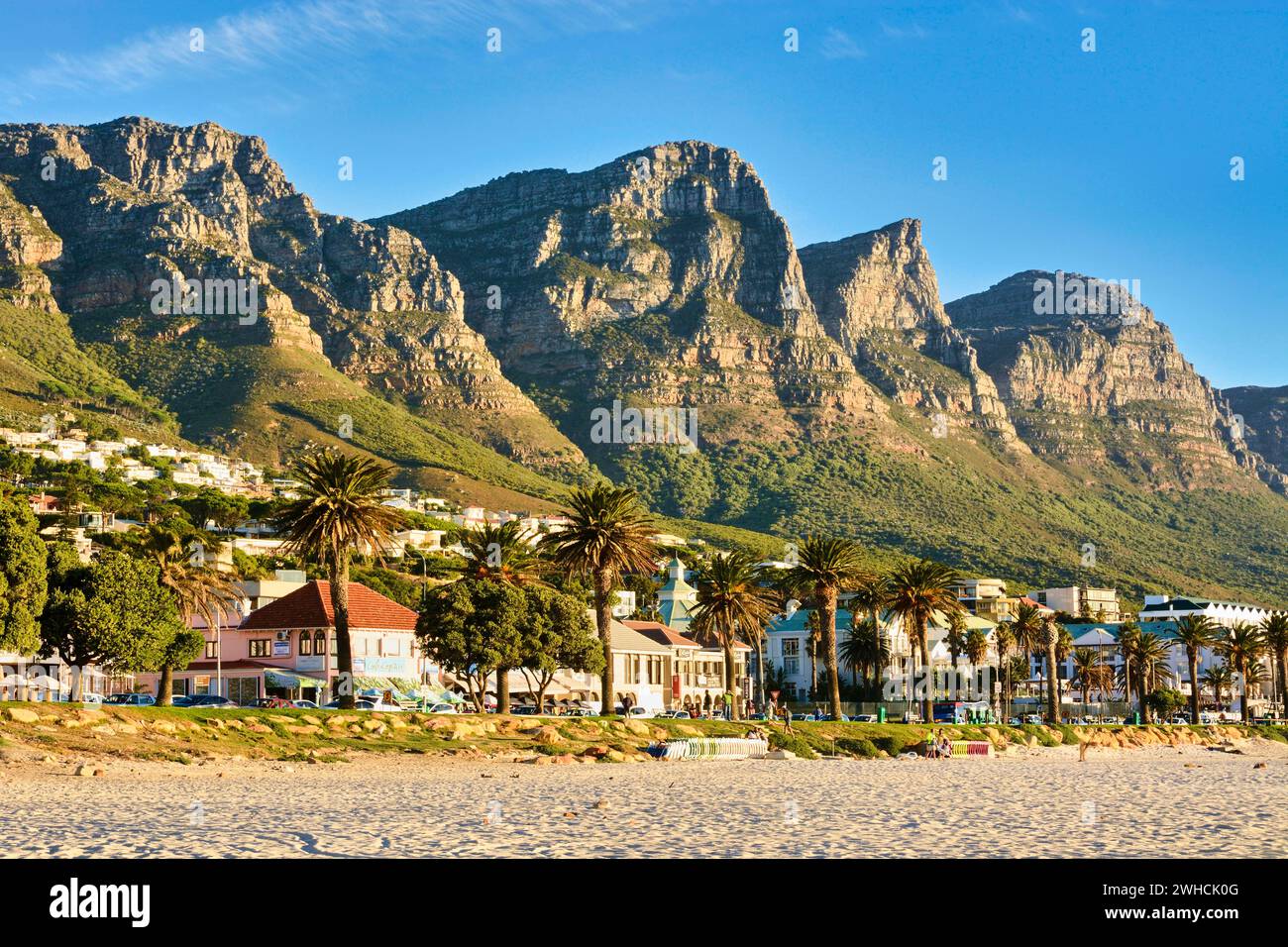 Beach in Cape Town, behind the rock formations The Twelve Apostles ...