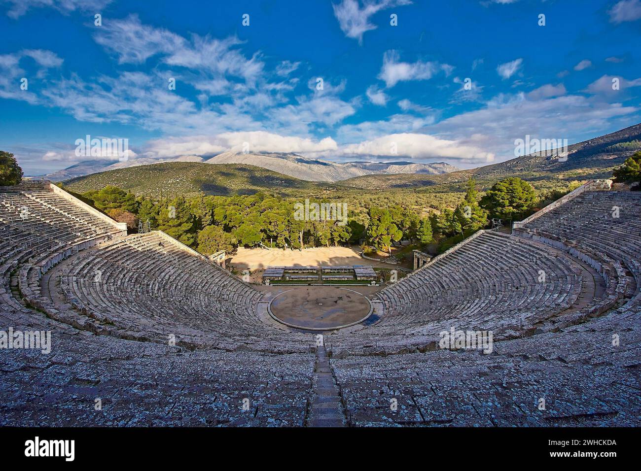 Wide view over an ancient amphitheatre with dynamic shadows and ...