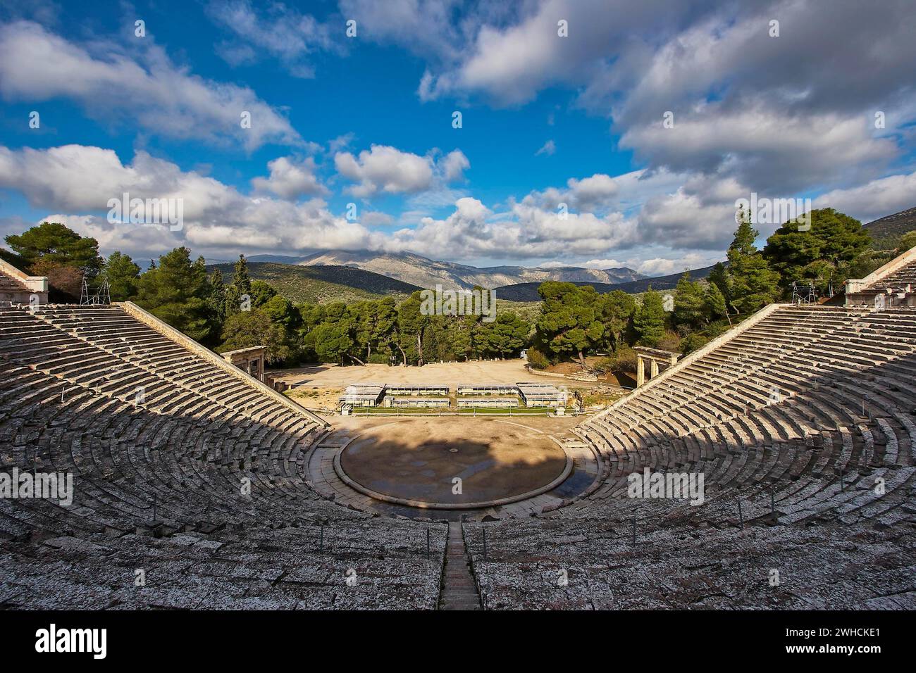 View from the centre of an ancient amphitheatre up to blue sky and ...