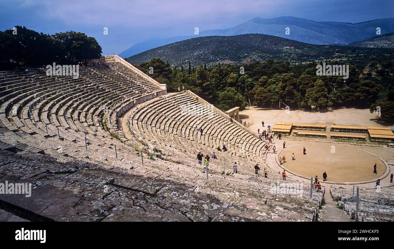 People explore the extensive ruins of an ancient amphitheatre with ...
