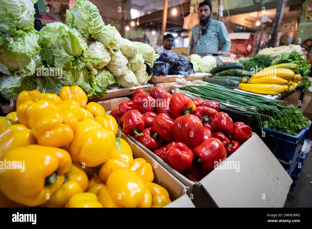 Vendor selling vegetables at a market, ahead of the presentation of the ...