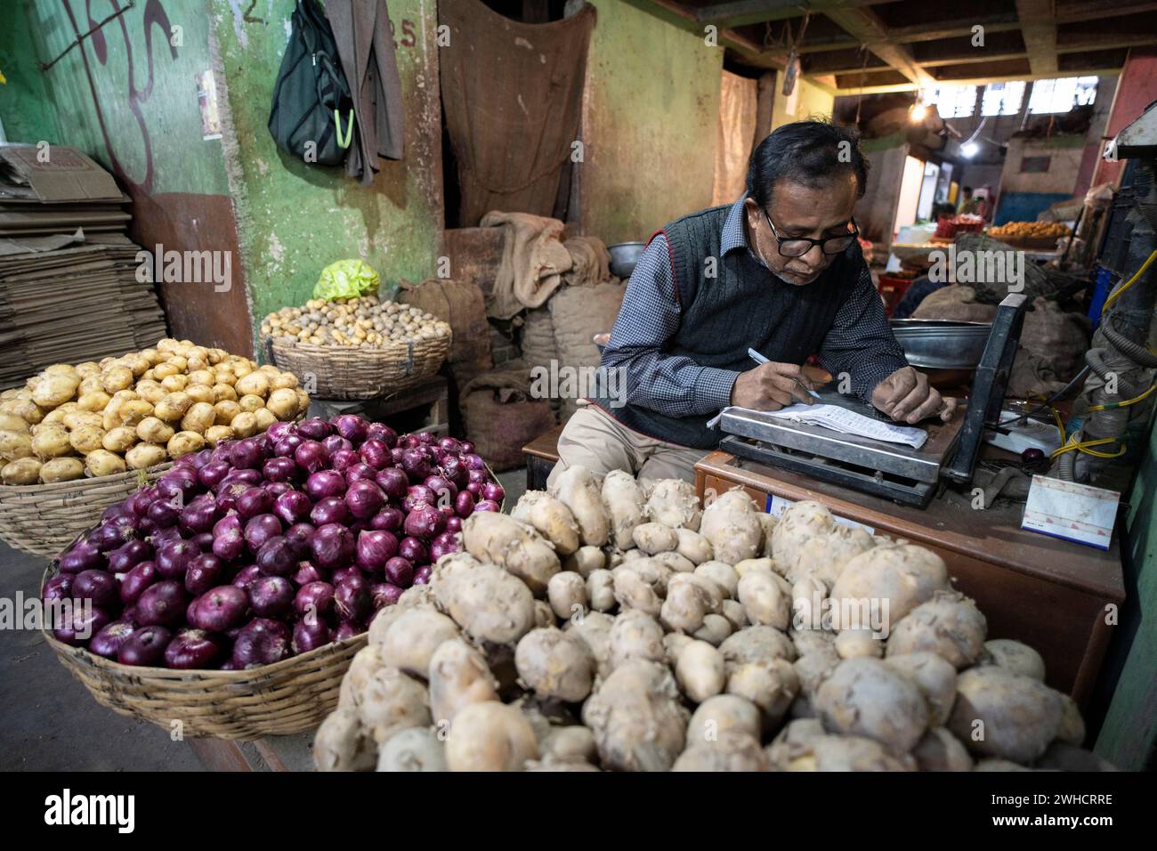 Vendor selling vegetables at a market, ahead of the presentation of the ...