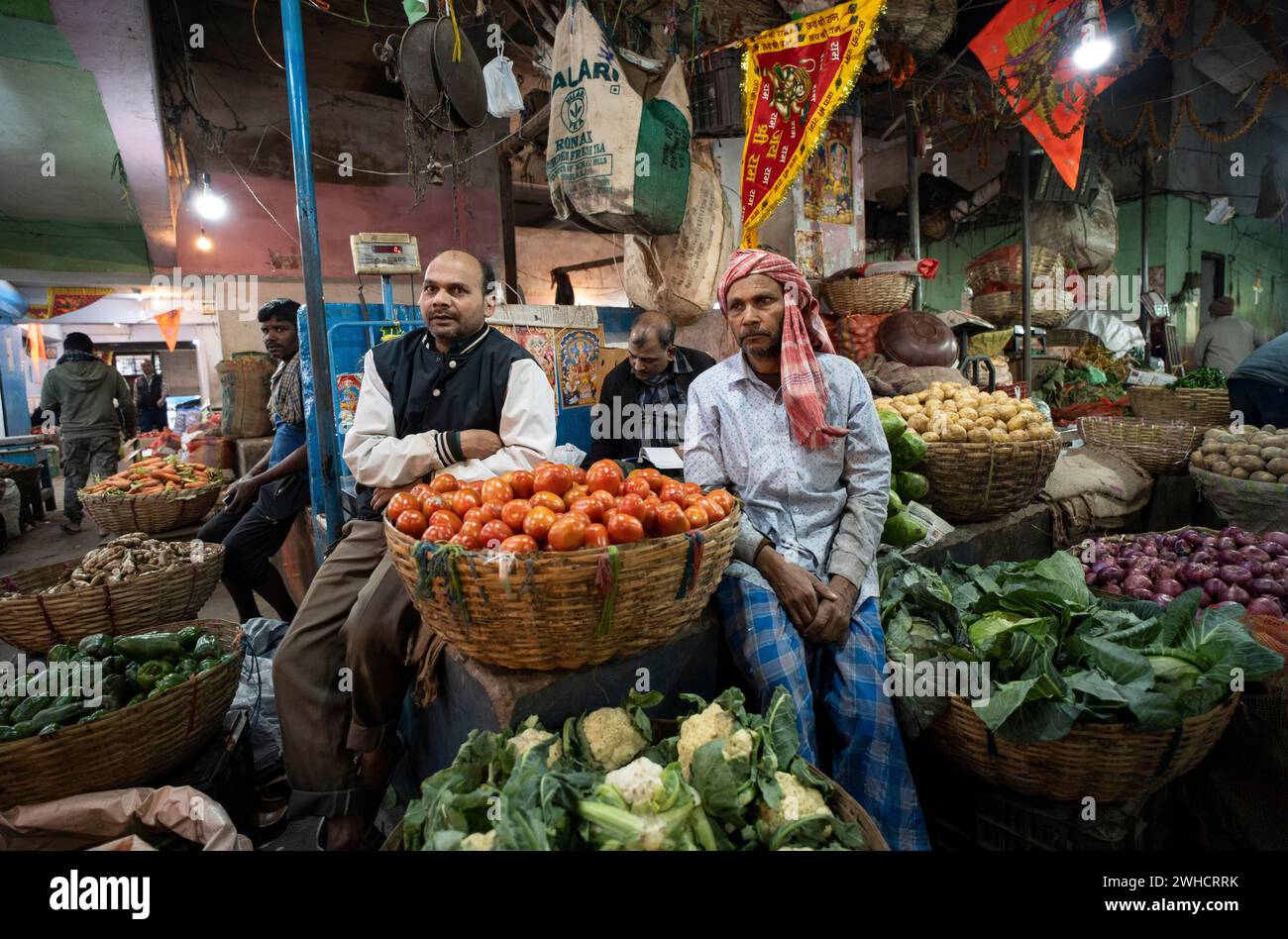 Vendor selling vegetables at a market, ahead of the presentation of the ...