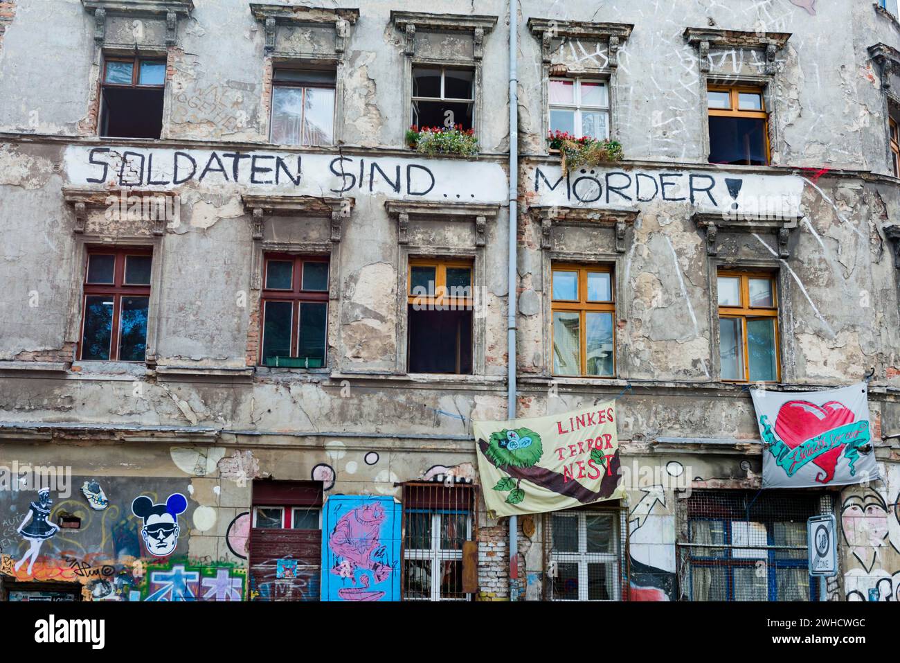 Covered wall with graffiti and political messages, left-wing political ...
