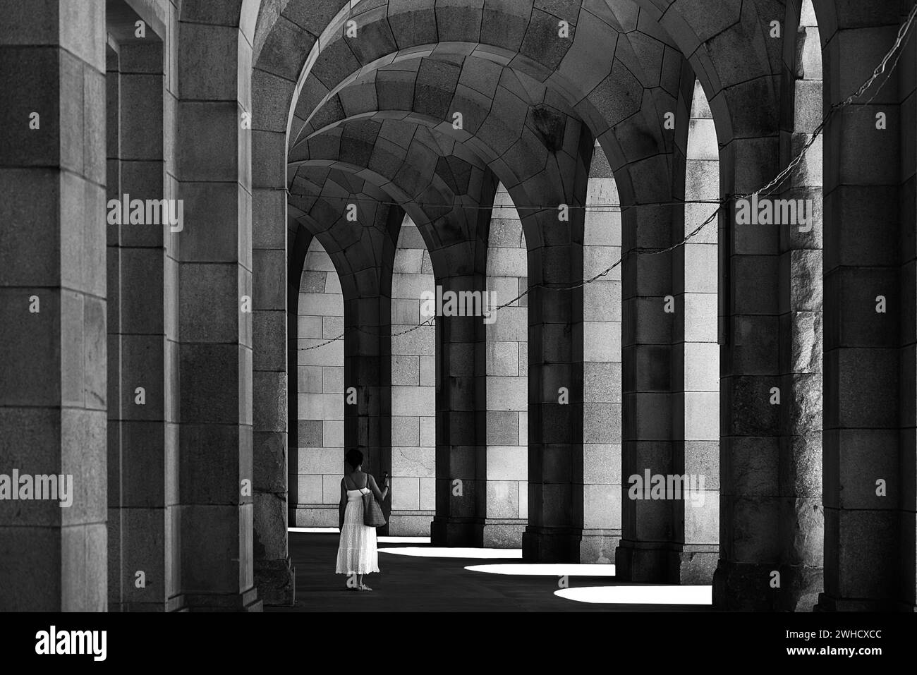 Lady in a white dress in the arcade of the Congress Hall, unfinished ...