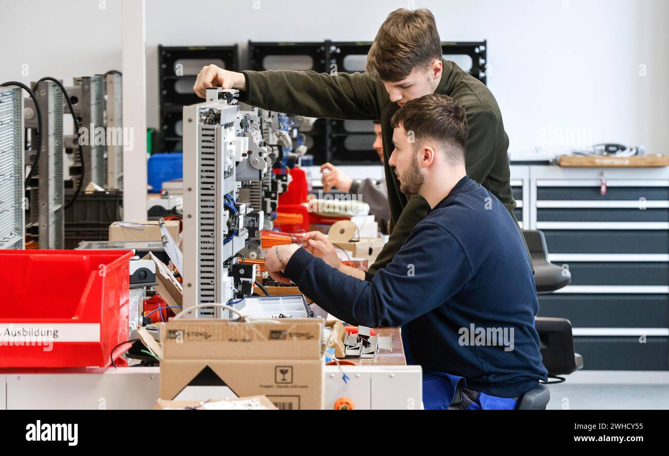An electronics apprentice assembles a motor protection relay at a ...