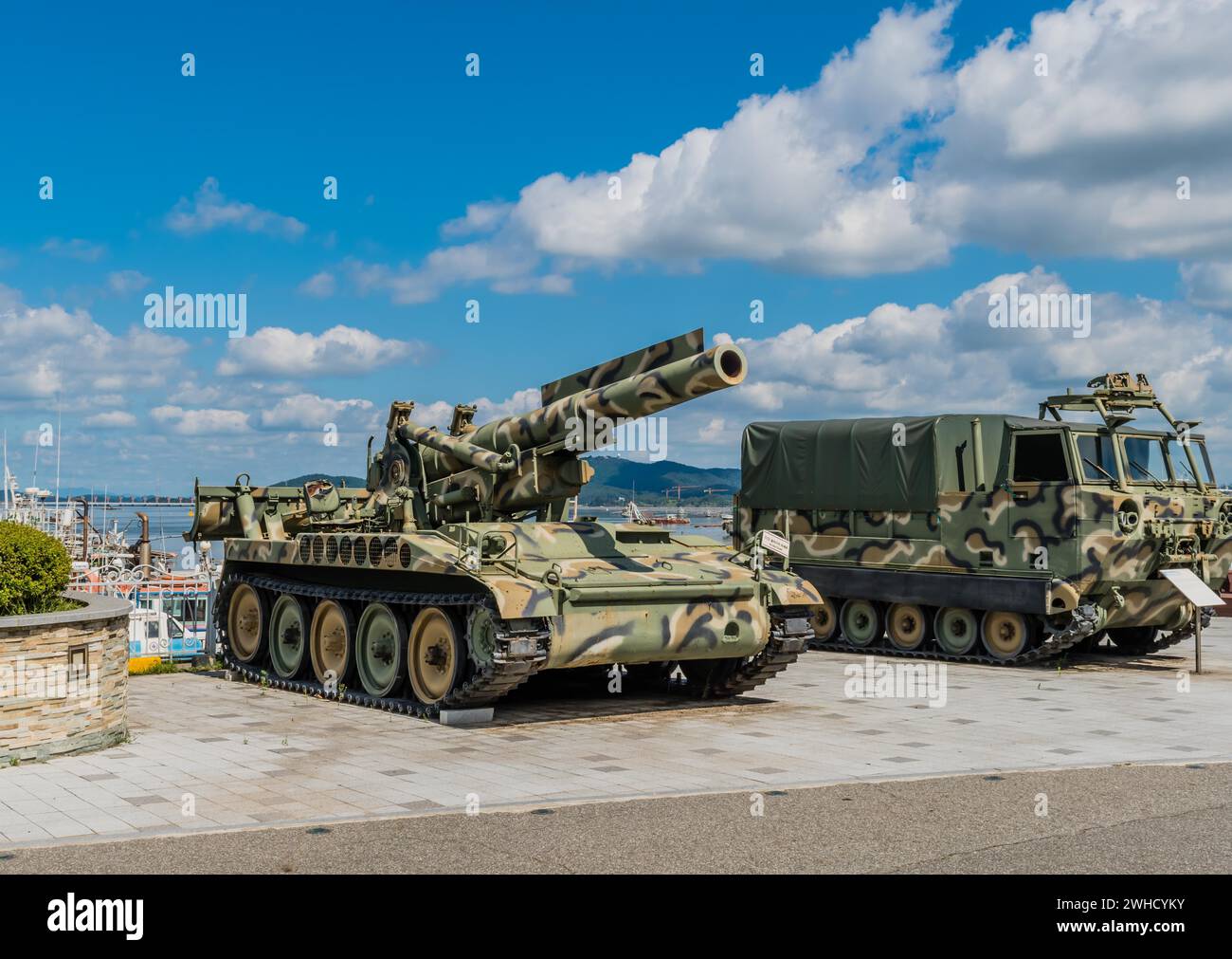 SeosanEight inch self-propelled gun beside M548 tracked cargo carrier ...