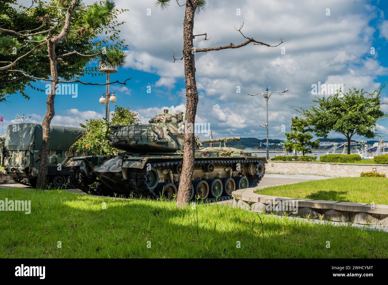 Rear side view of M48 tank on display at seaside park under blue cloudy ...