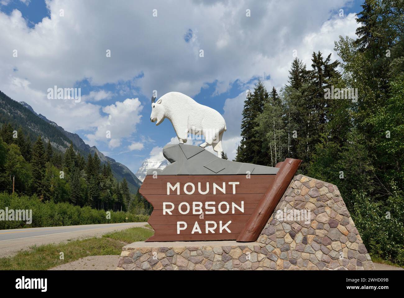 Sign with snow goat sculpture at the park entrance in front of Mount ...